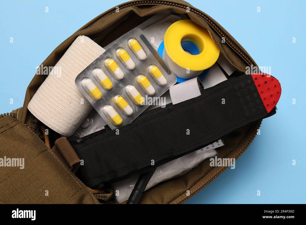 Military first aid kit on light blue background, top view Stock Photo ...