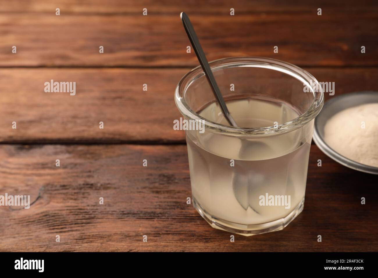 Glass of agar-agar jelly on wooden table. Space for text Stock Photo ...