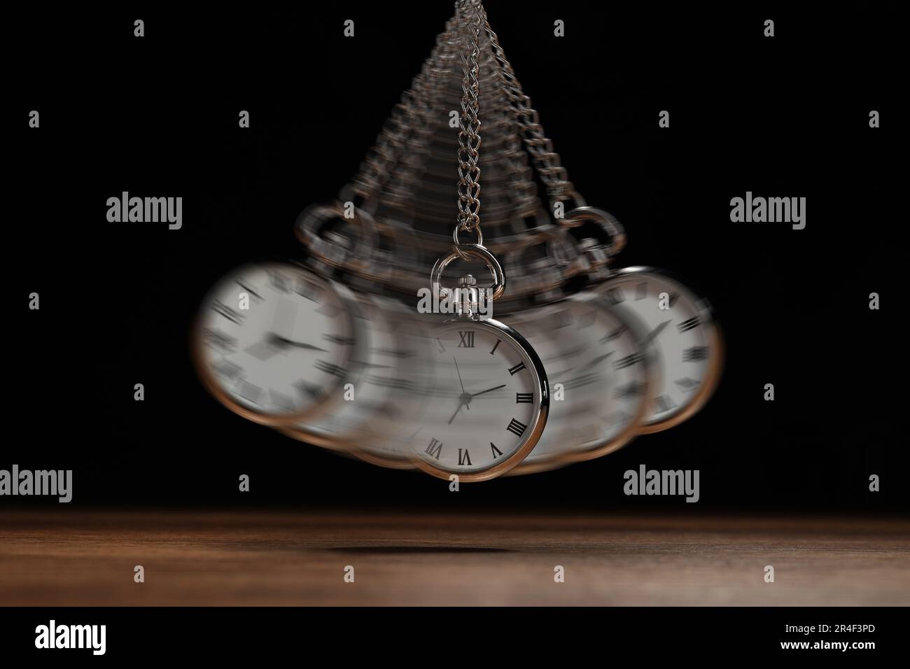 Hypnosis session. Vintage pocket watch with chain swinging over wooden ...