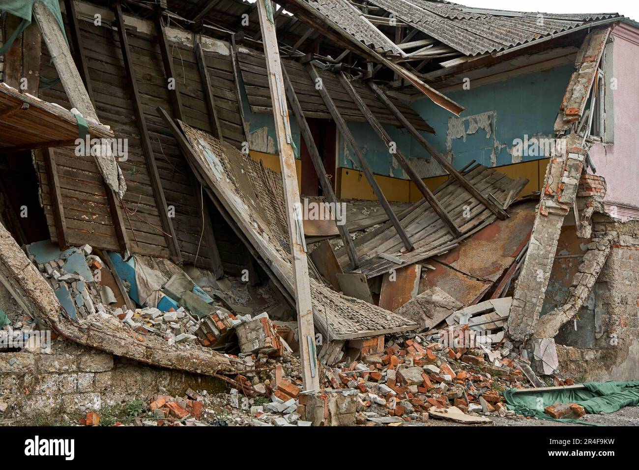 An abandoned two-story building with a crumbling roof Stock Photo - Alamy