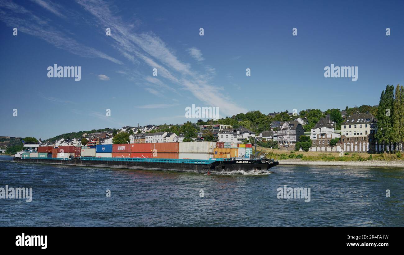 Heavily loaded River Barge on the Rhine River as it passes a quaint ...