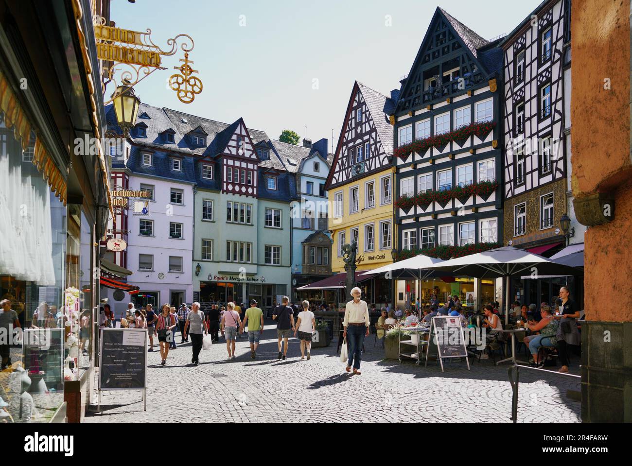 Tourists enjoy summer at a typical medieval town square in Germany ...