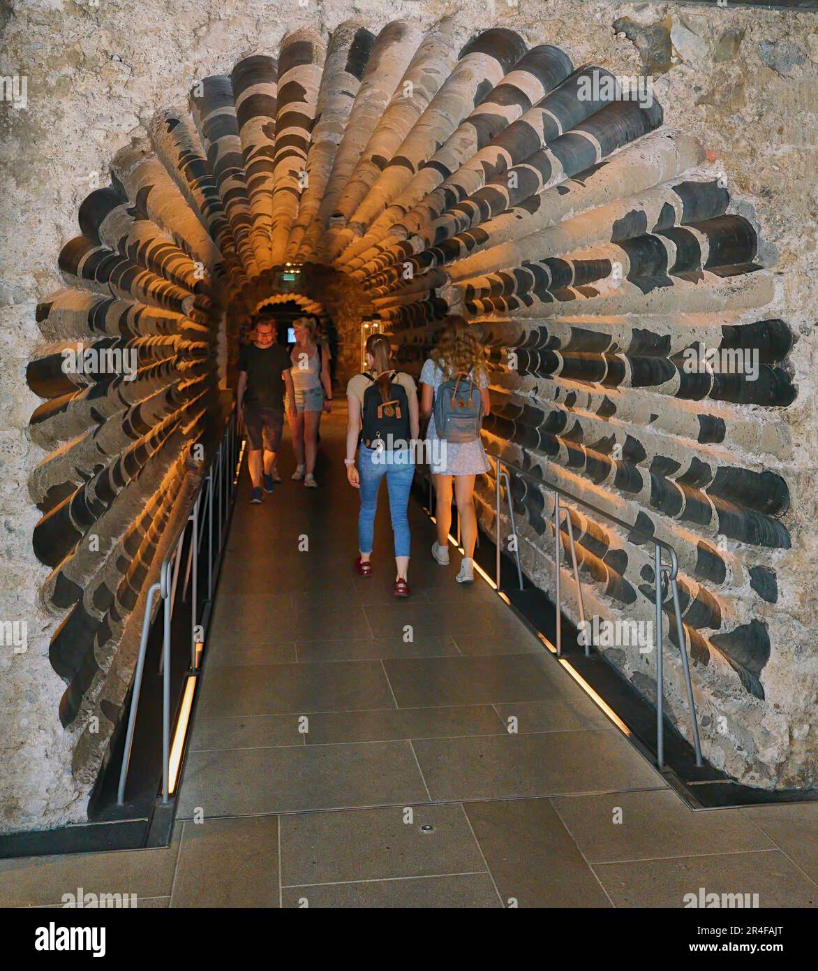 Tourist pass through tunnel blasted through the foundation of the ...