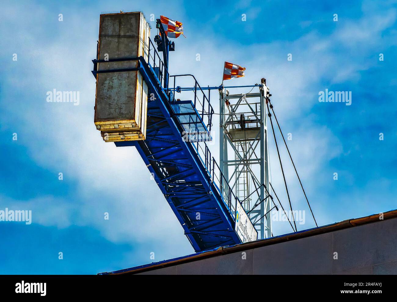 A construction crane stands over a building Stock Photo - Alamy