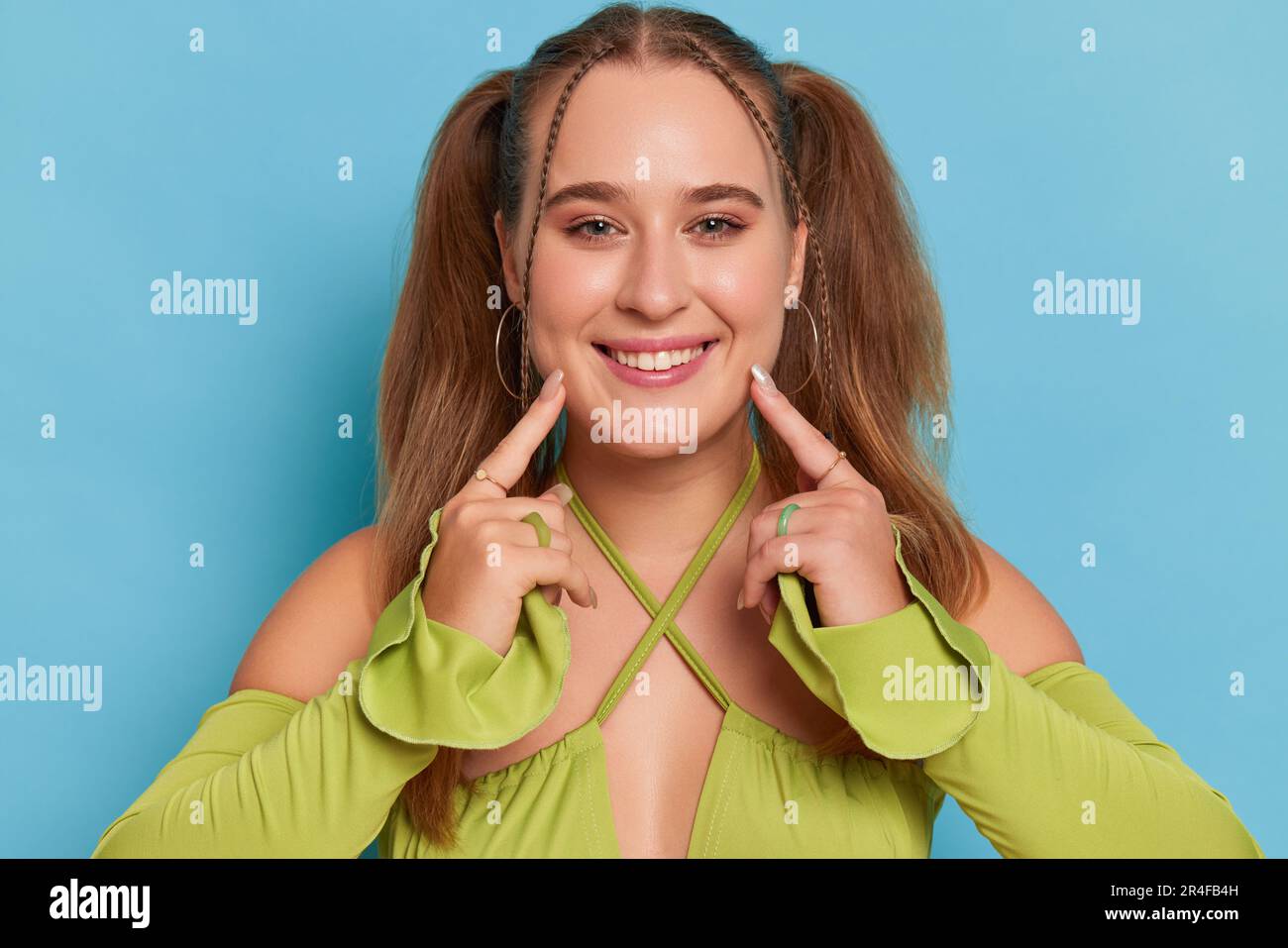 Cute Young Lady Smiling Touching Her Face With Fingers Wearing