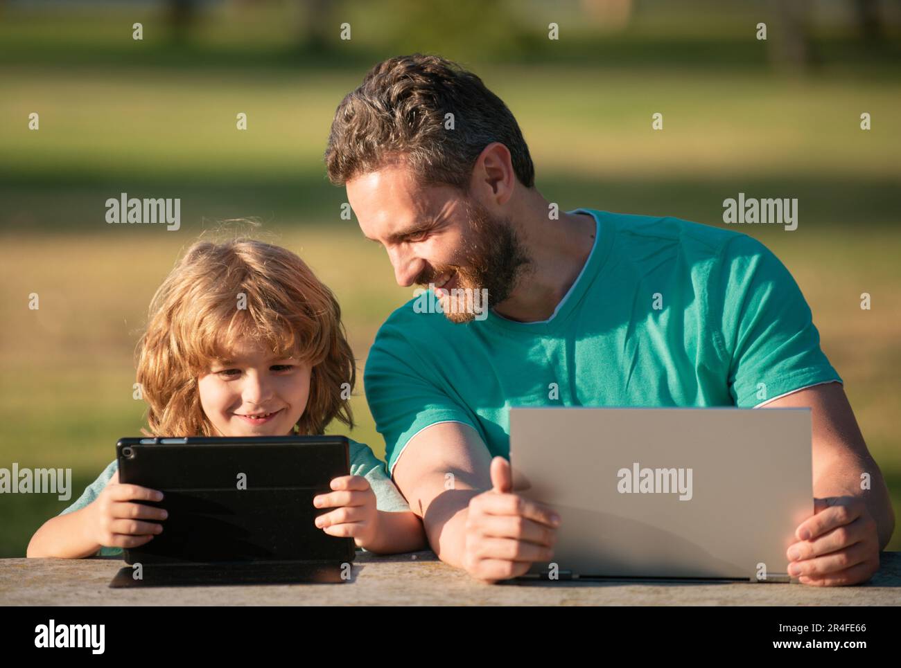Father teaching son to use laptop, dad and school boy child looking ...