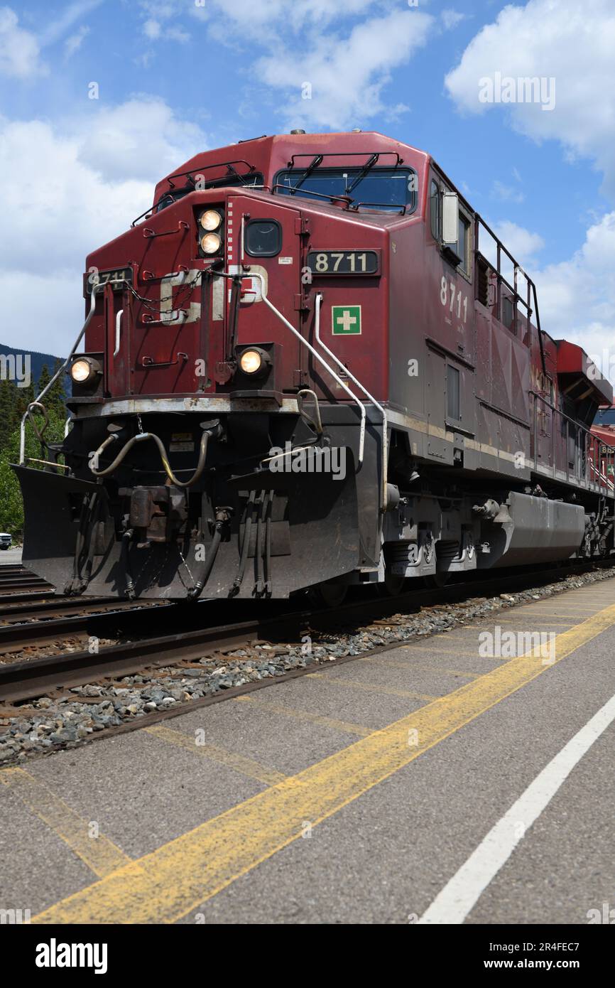 A Canadian Pacific diesel freight train powering though Banff, Alberta, Canada with 130 freight ...