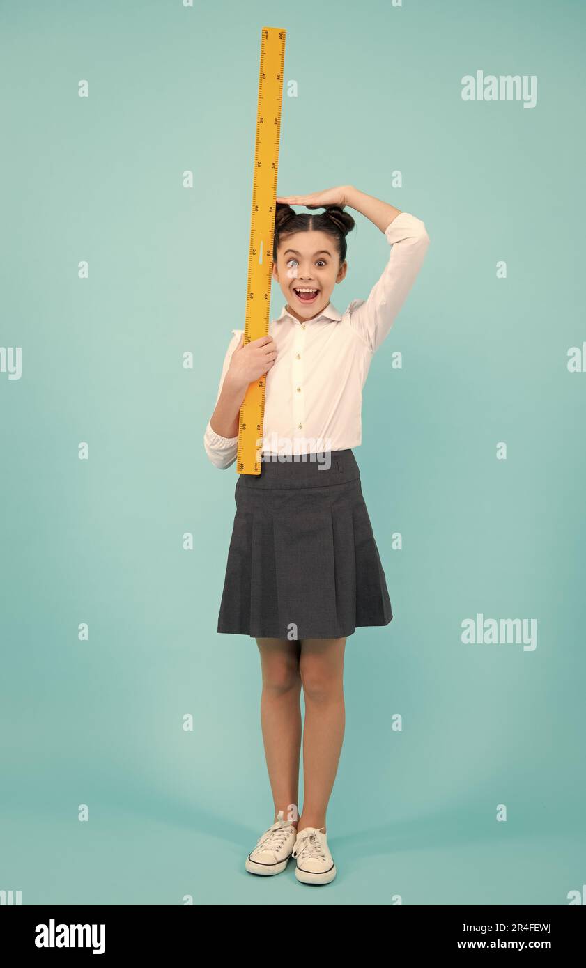 Kid height measure, growth measurement. School girl holding measure for ...