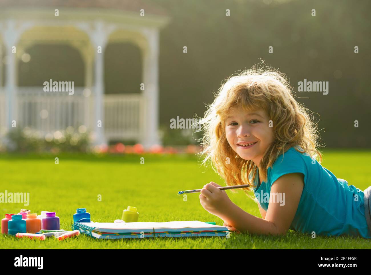 Children draw paint pictures outside, childrens creativity. Child boy ...