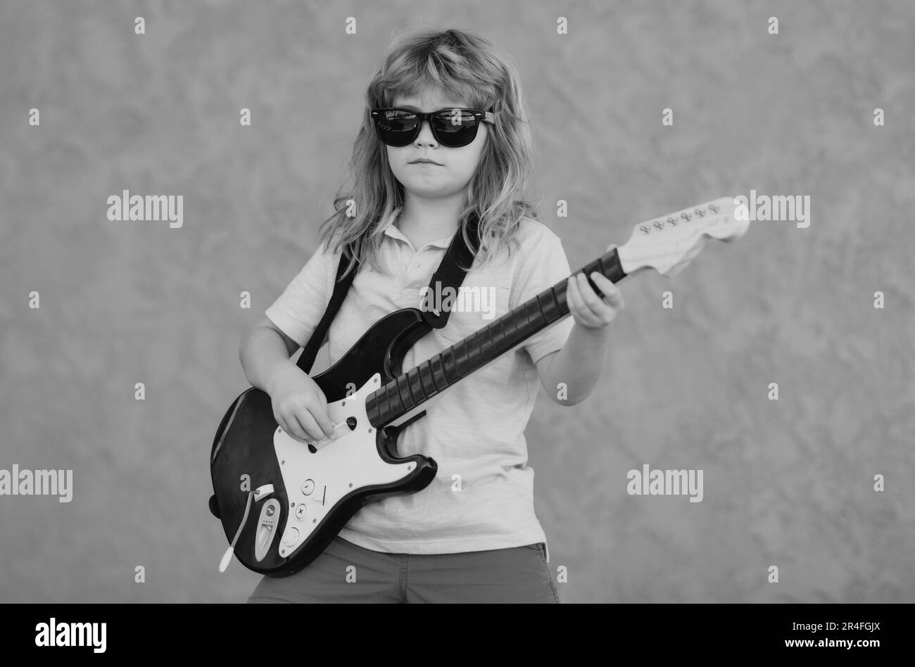 Child musician guitarist playing electric guitar. Funny child with ...