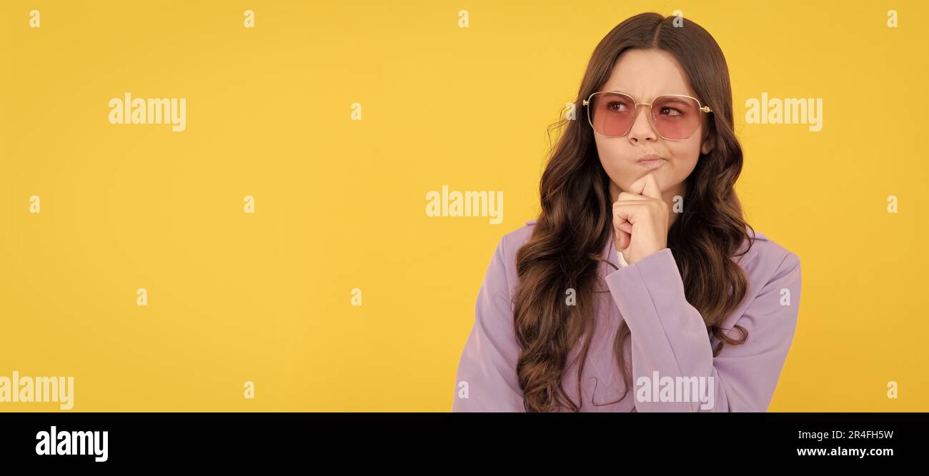 thoughtful kid with curly hair in sunglasses. beauty and fashion ...
