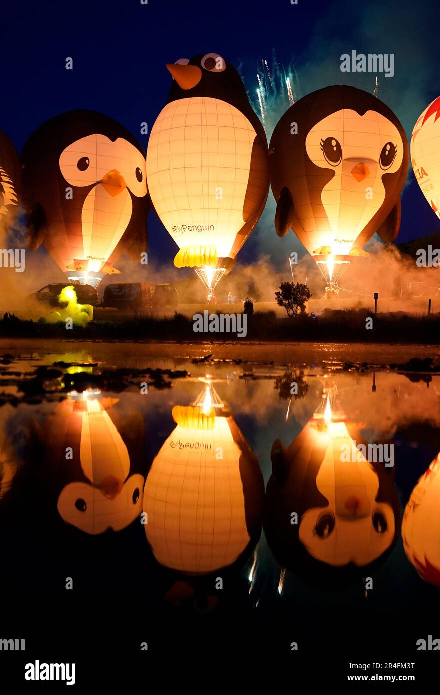 Balloons light up as they are tethered to the ground as they take part ...