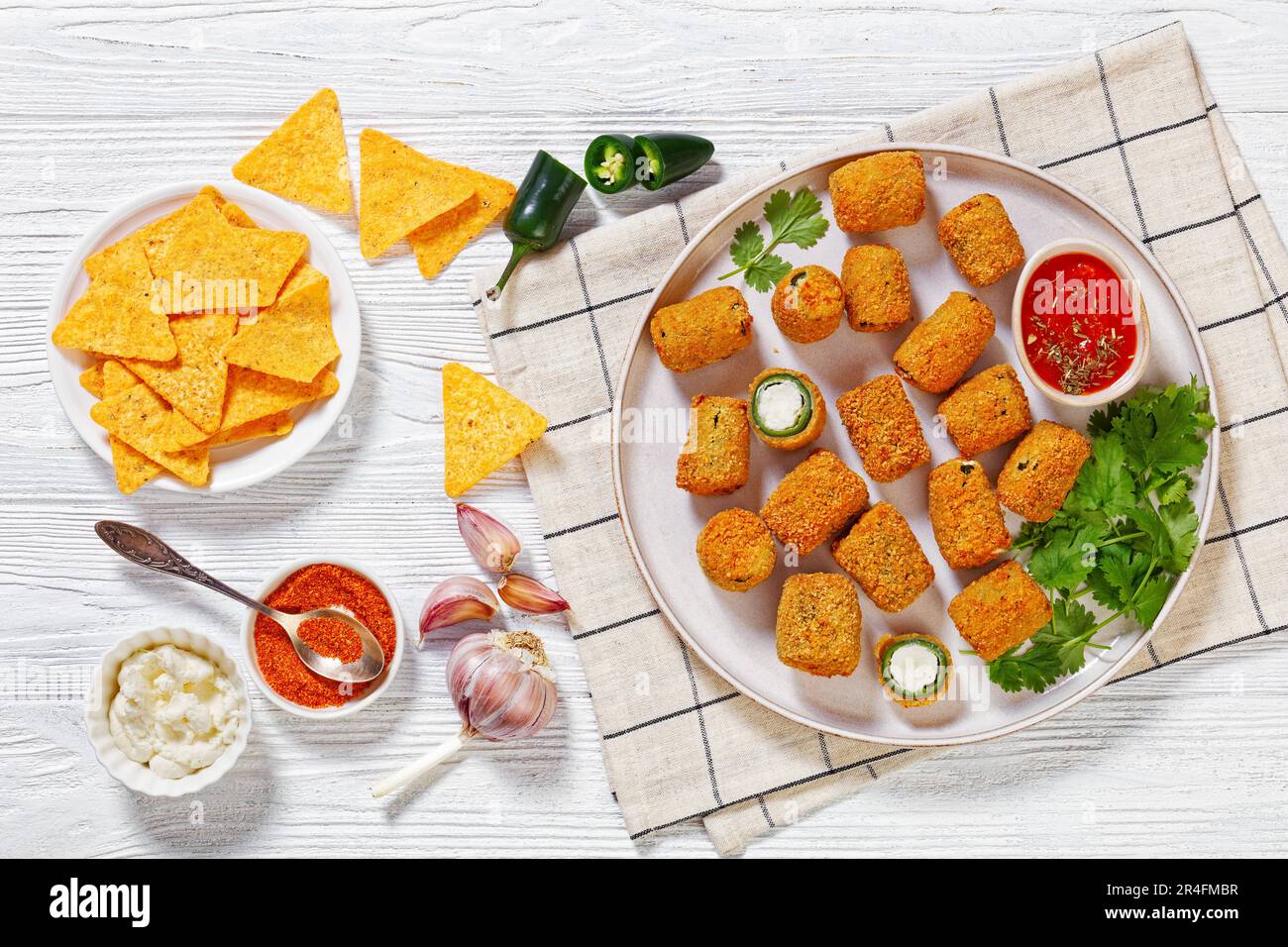 crispy fried jalapeno poppers with melted cream cheese filling on white ...