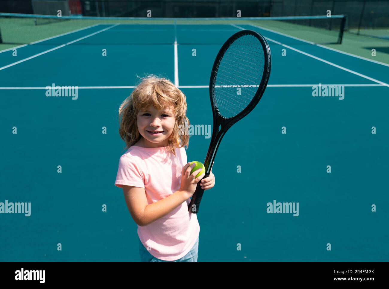 Child boy tennis beginner player on outdoor tennis court Stock Photo ...
