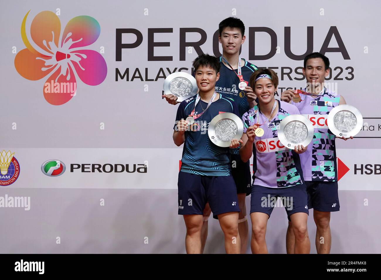 Thailand's Dechapol Puavaranukroh, right, and Sapsiree Taerattanachai, second right, pose for ...