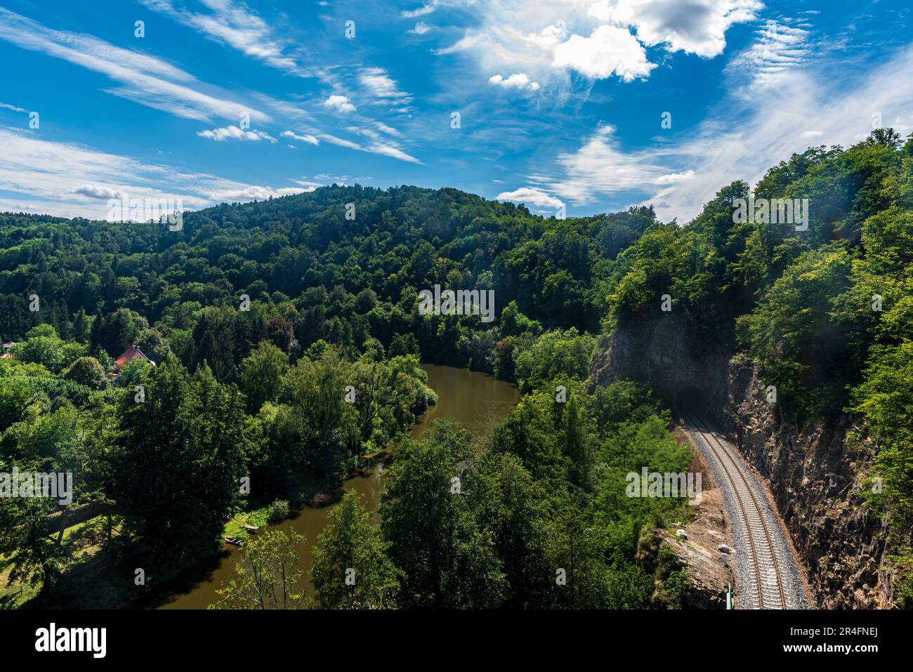 Sazava river with forest covere hills and railroad track with tunnel ...