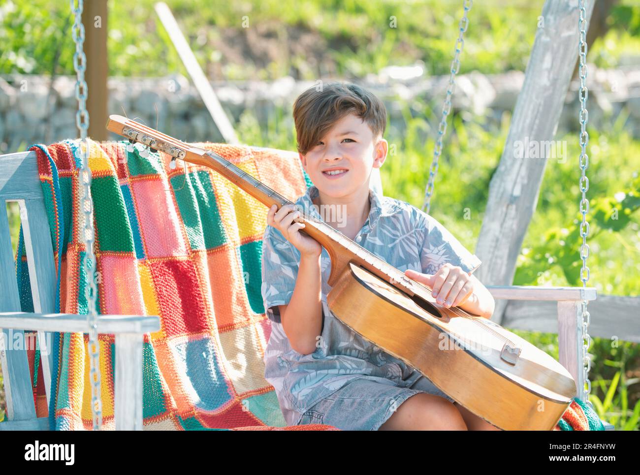 Musician child playing guitar. Kid boy singing and playing guitar ...