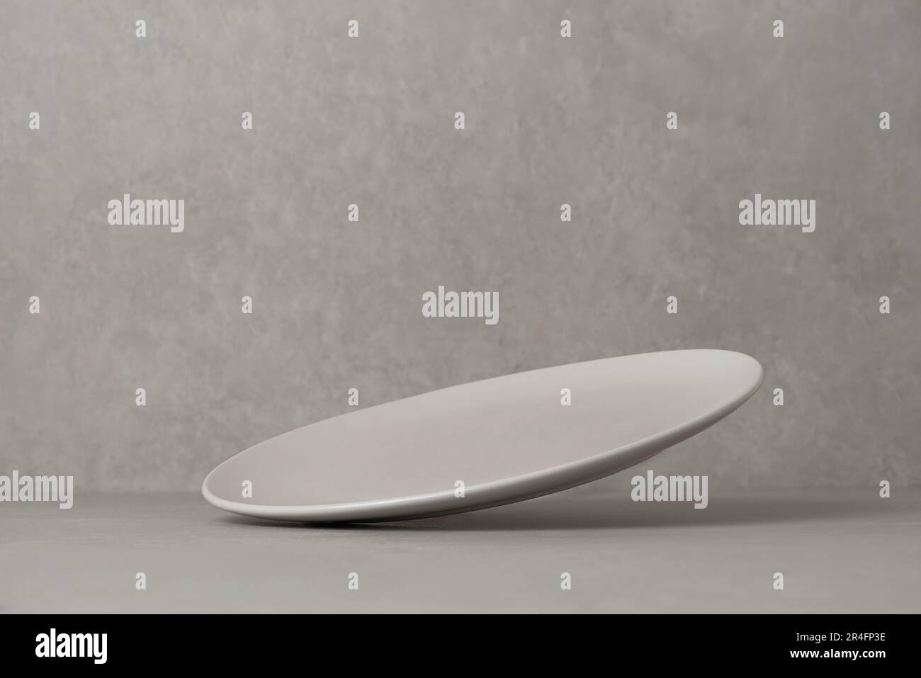 Empty plate falling on the table. Levitation, flying saucer Stock Photo ...