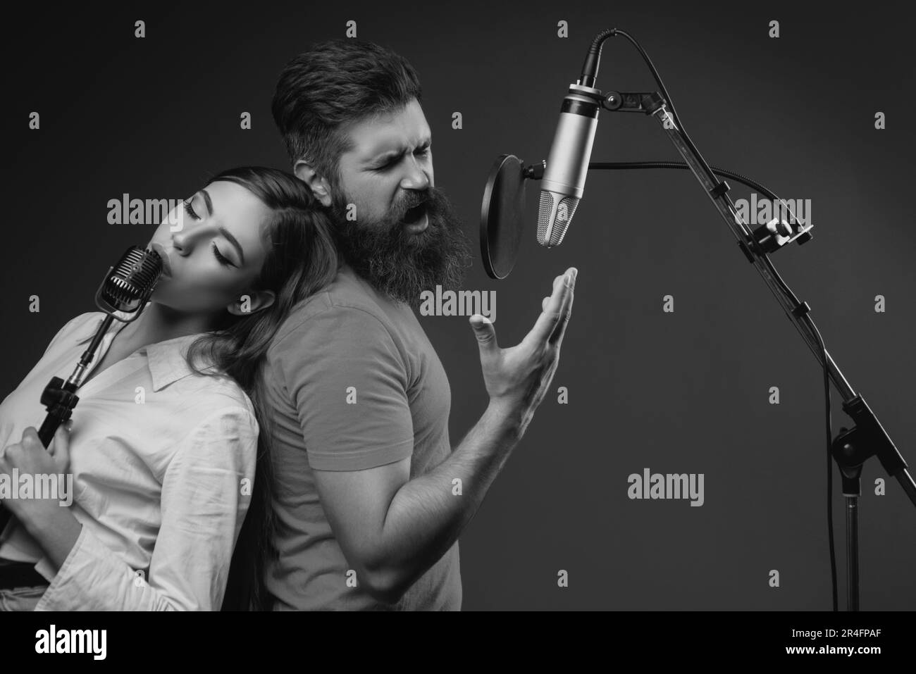 Couple singing. Singer coupl is performing a song with a microphone ...