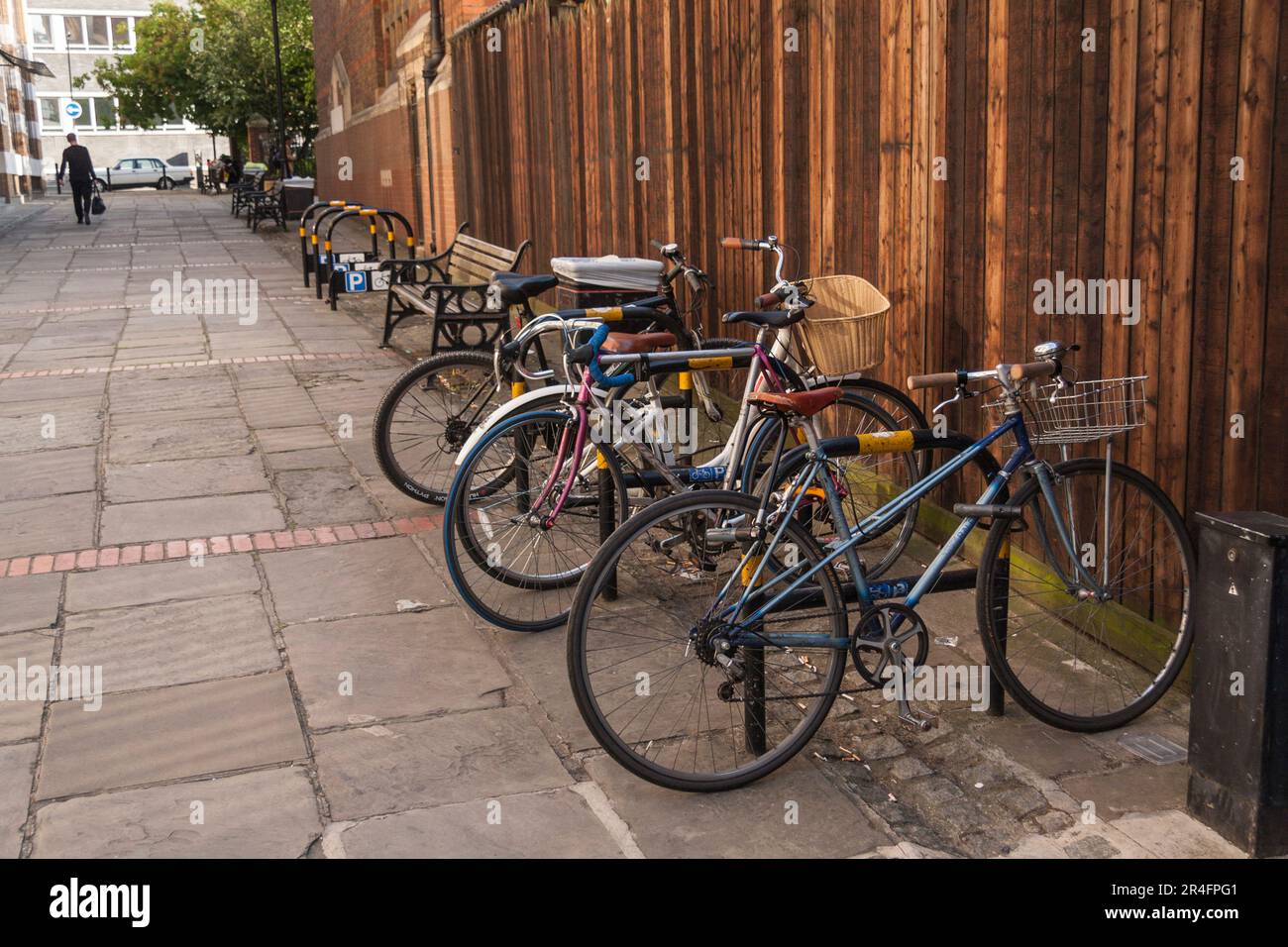 Old fashioned bicycles fastened to bike rack in London Stock Photo - Alamy