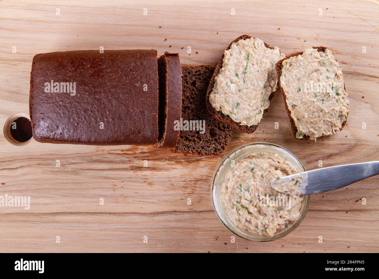 Delightful pate and slices of bread arranged tastefully on wooden table ...