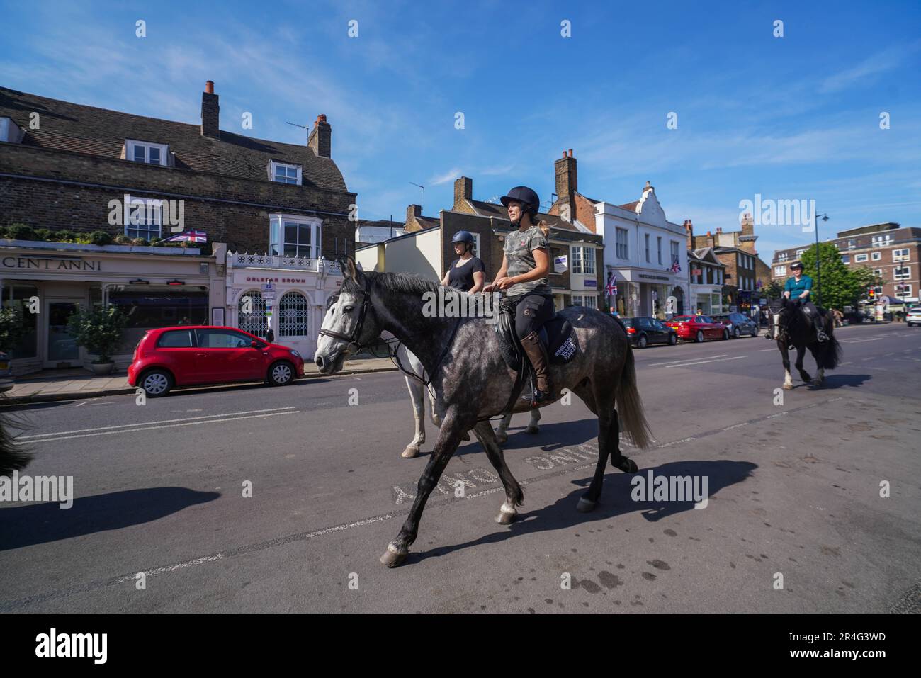 London UK. 28 May 2023 Horse riders pass through Wimbledon village in ...