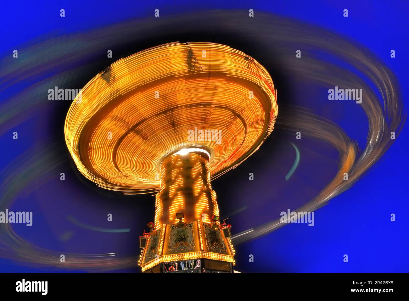Chain carousel in the blue hour Stock Photo - Alamy