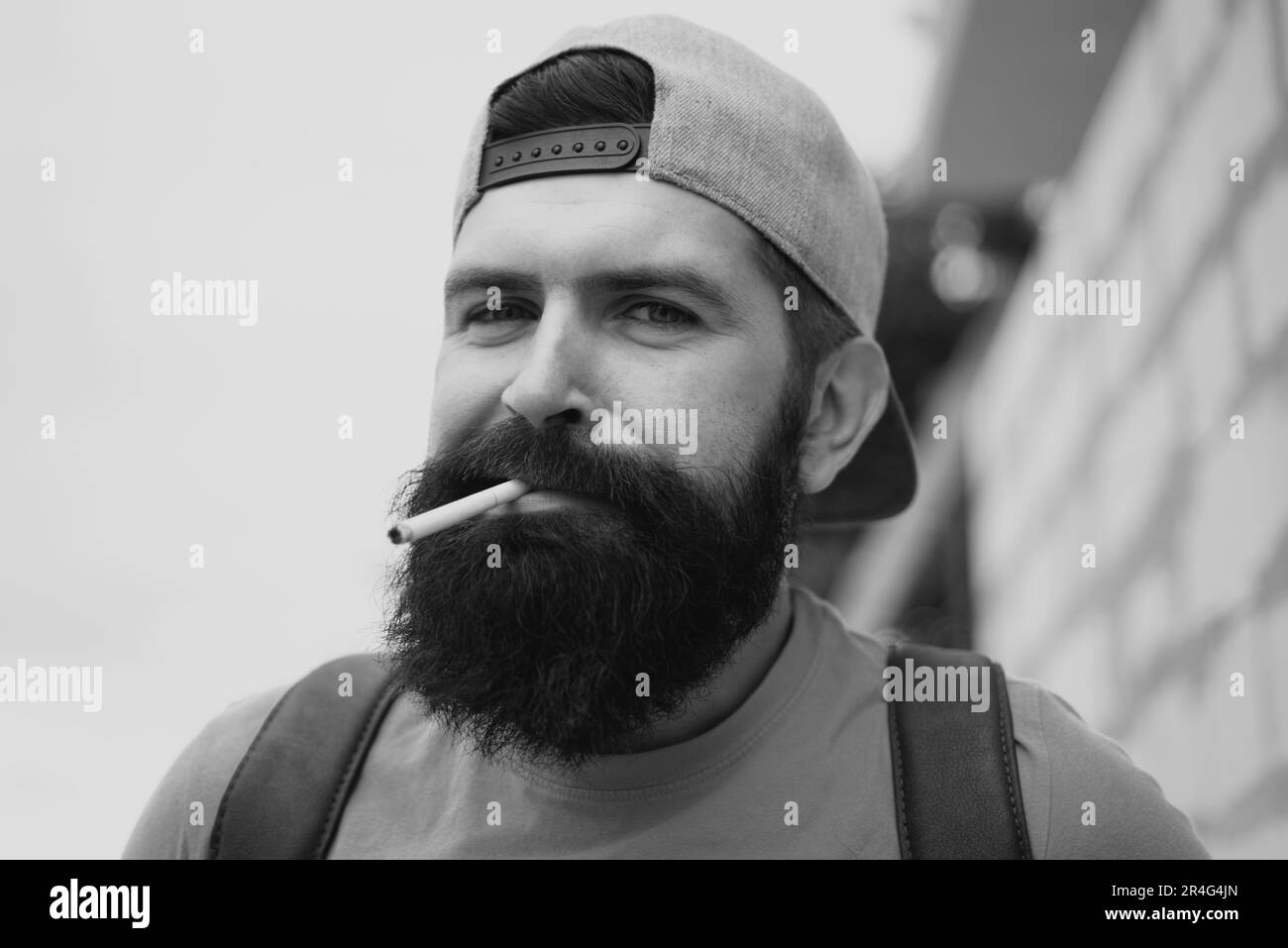Handsome guy smoking outside in urban. Man smoking cigarette Stock ...