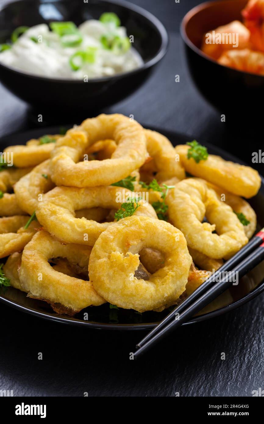 Fried calamari rings with yogurt garlic dip Stock Photo - Alamy