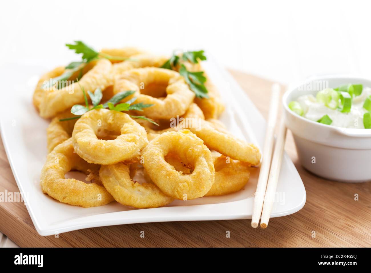 Fried calamari rings with yogurt garlic dip Stock Photo - Alamy