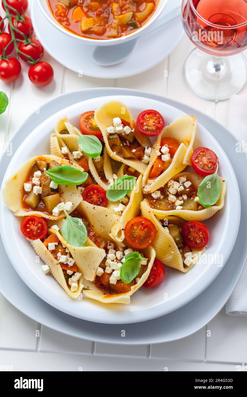 Pasta with vegetable stew with mozzarella and basil Stock Photo - Alamy