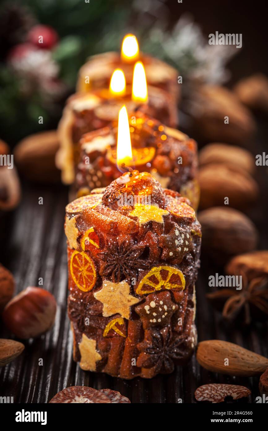 Rustic aromatic Christmas candles with spices and nuts Stock Photo - Alamy