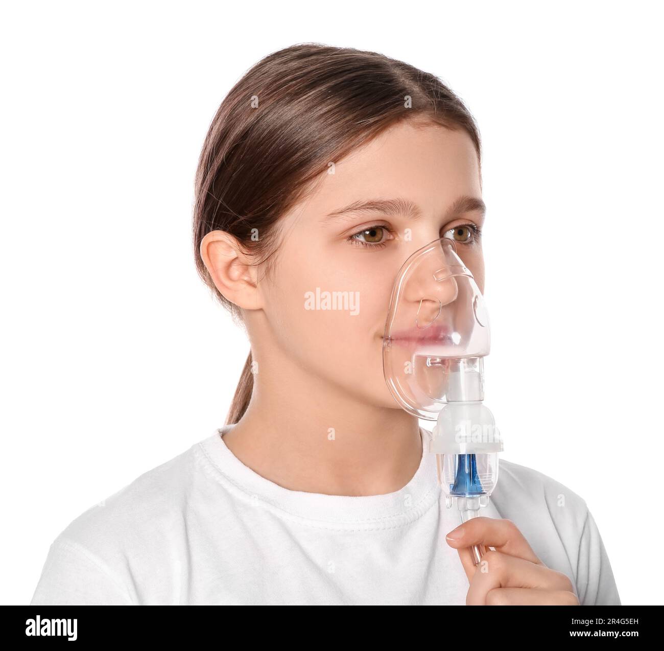 Cute girl using nebulizer for inhalation on white background Stock ...