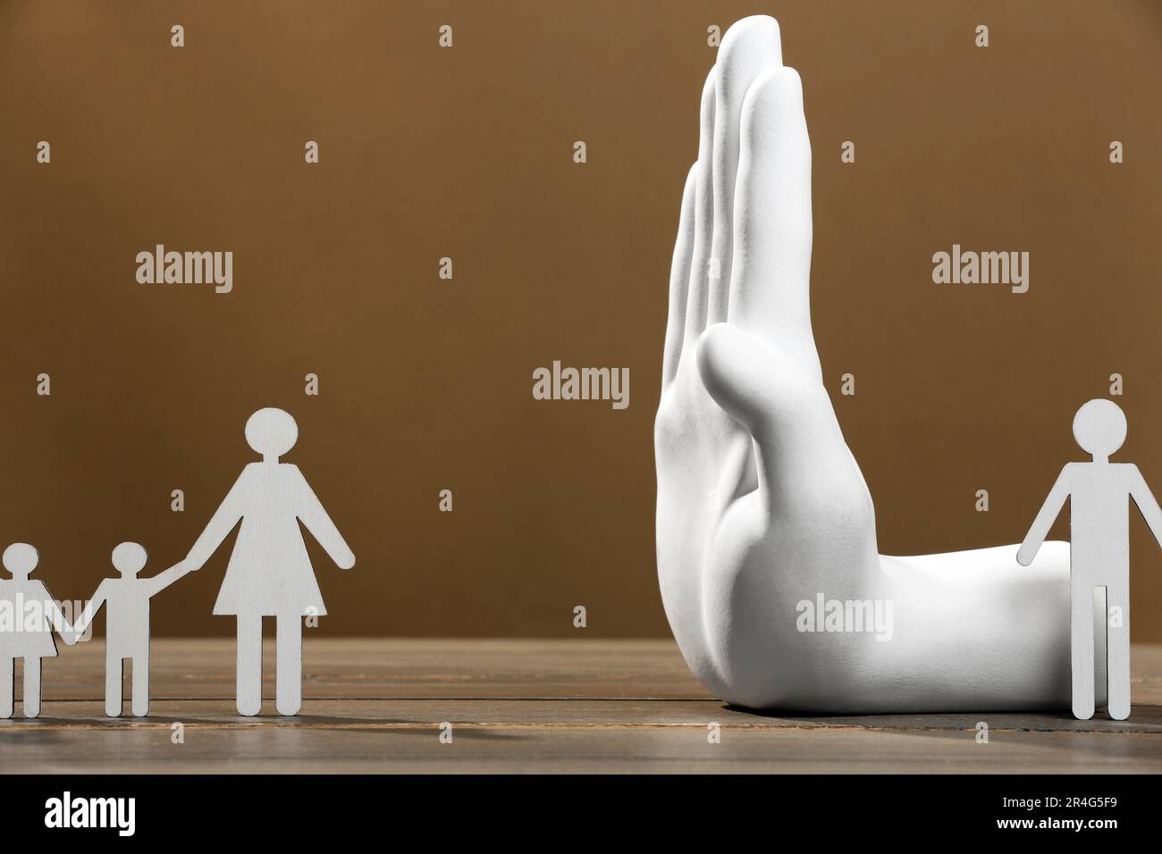 Divorce concept. Hand model dividing paper figures of woman with ...