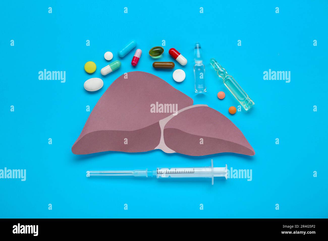 Paper liver, syringe, vials and pills on light blue background, flat ...