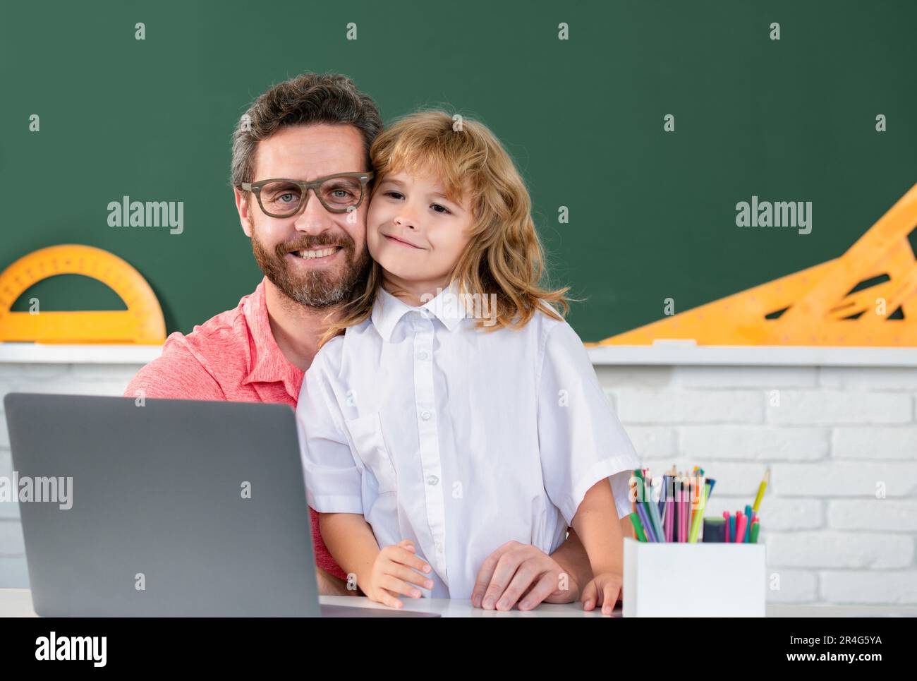 Back to school. Teacher and pupil boy learning in the classroom Stock ...