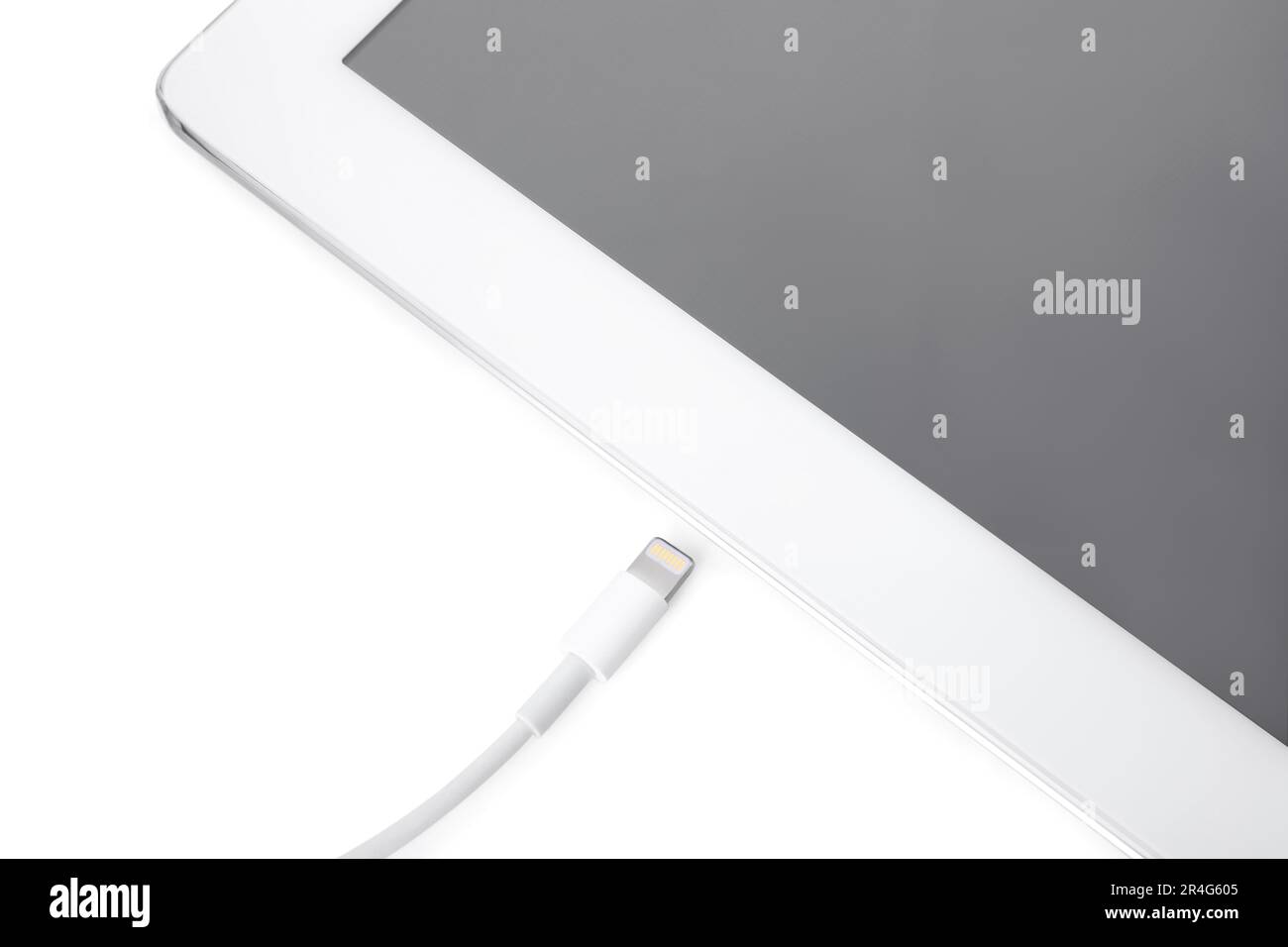 USB cable with lightning connector and tablet on white background Stock ...