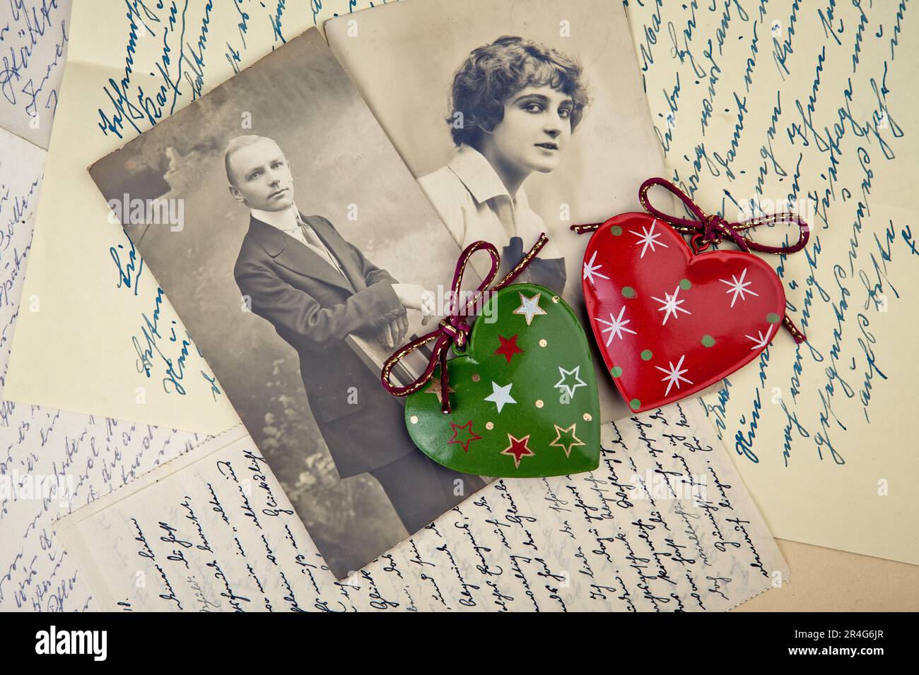 Old photos of man and woman on old handwritten letters and two hearts ...