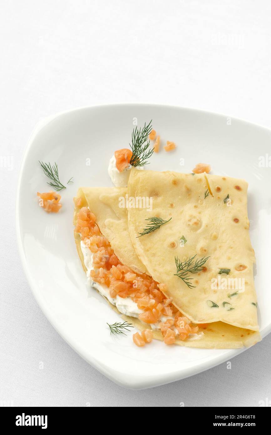 swedish smoked salmon and sour cream crepe pancake on white background ...