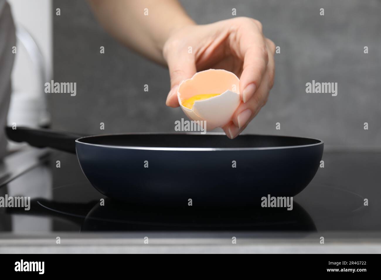 Woman breaking egg frying hi-res stock photography and images - Alamy