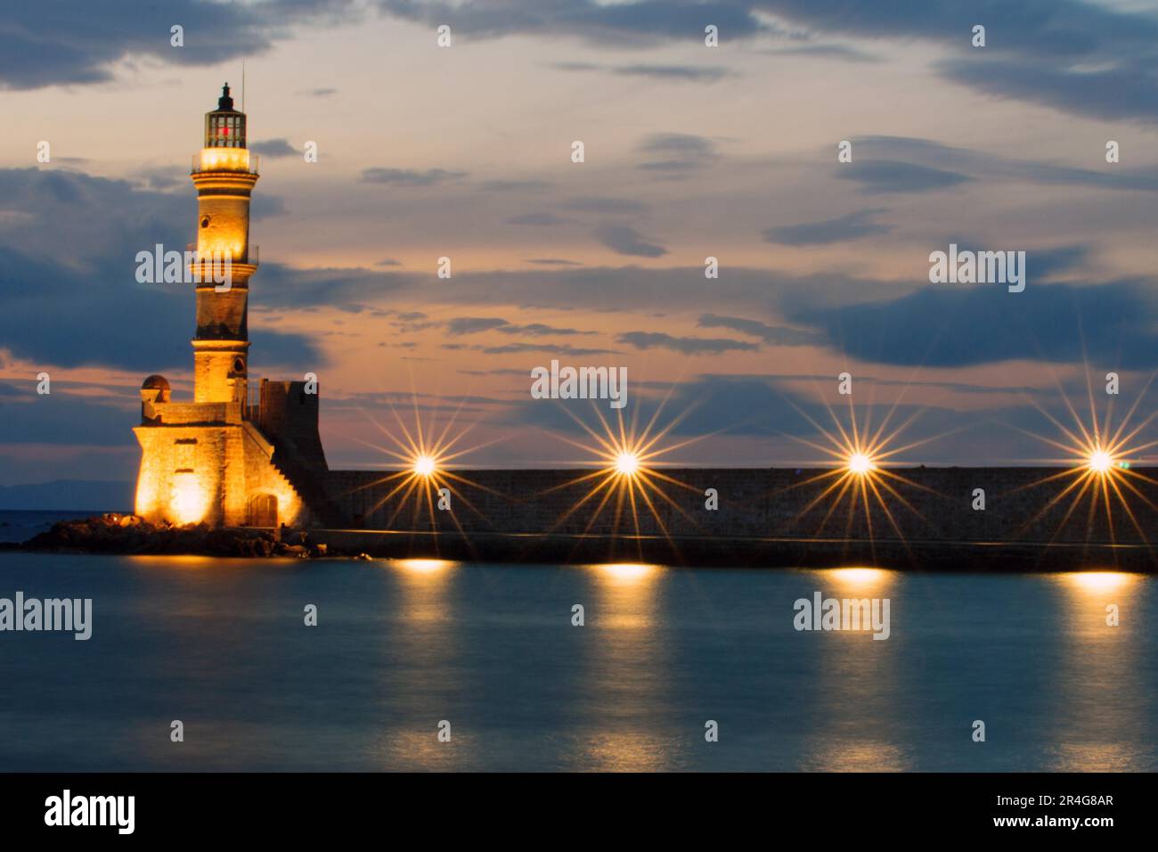 The lighthouse of Chania in Crete after sunset Stock Photo - Alamy