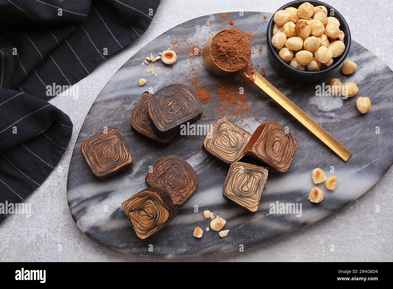Flat lay composition with tasty chocolate candies and nuts on light ...