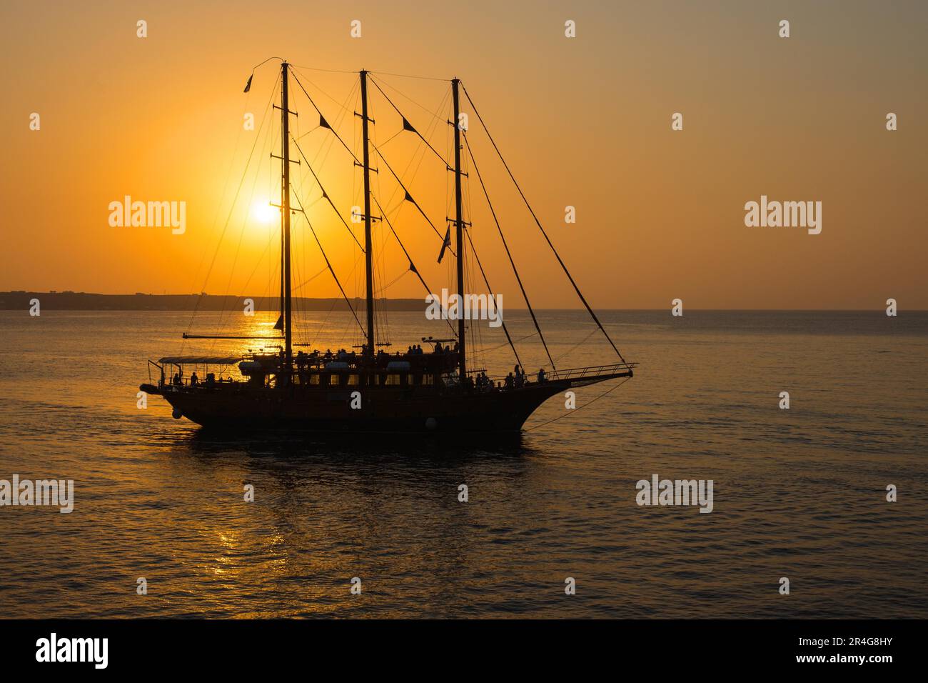 Sunset with sailing ship on Santorini Stock Photo - Alamy