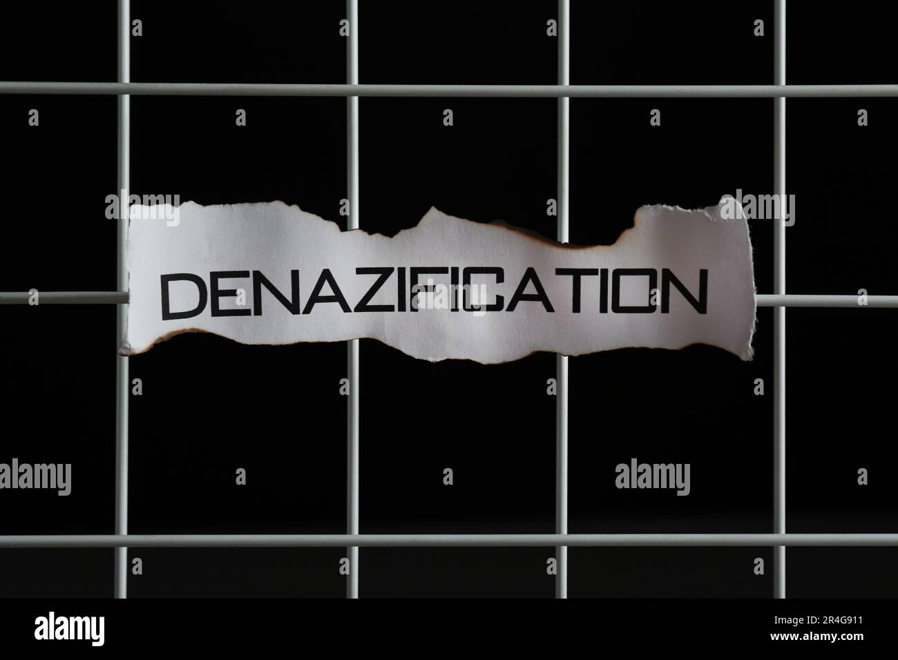 Paper with word Denazification on lattice against black background ...