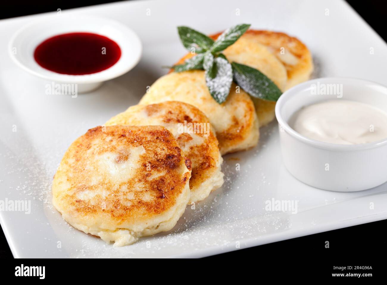 cottage cheese pancake with sour cream and syrup Stock Photo - Alamy