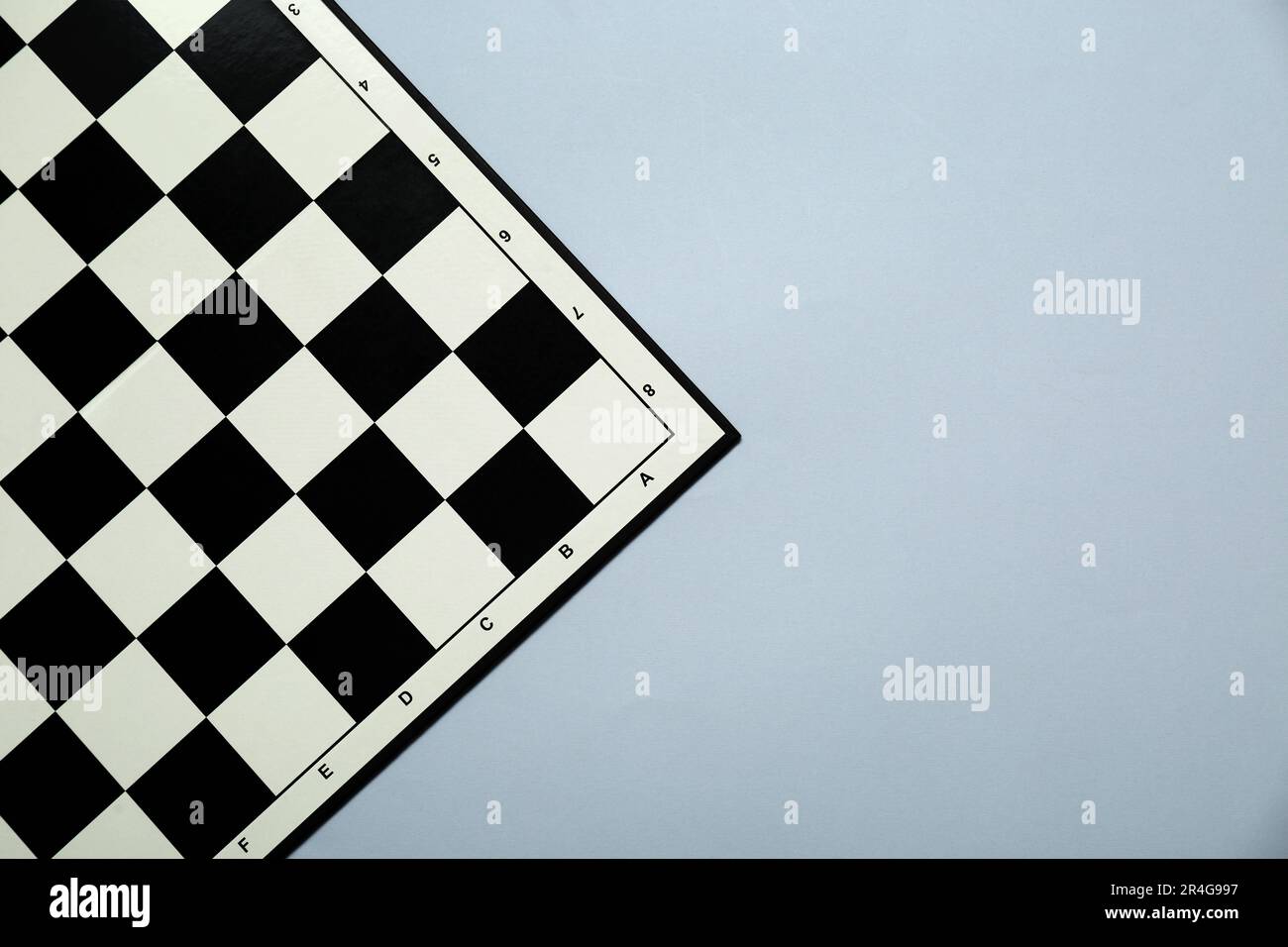 Black and white empty checkerboard on light grey background, top view ...