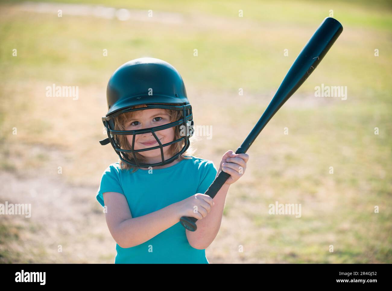 Little child baseball player focused ready to bat. Kid holding a ...