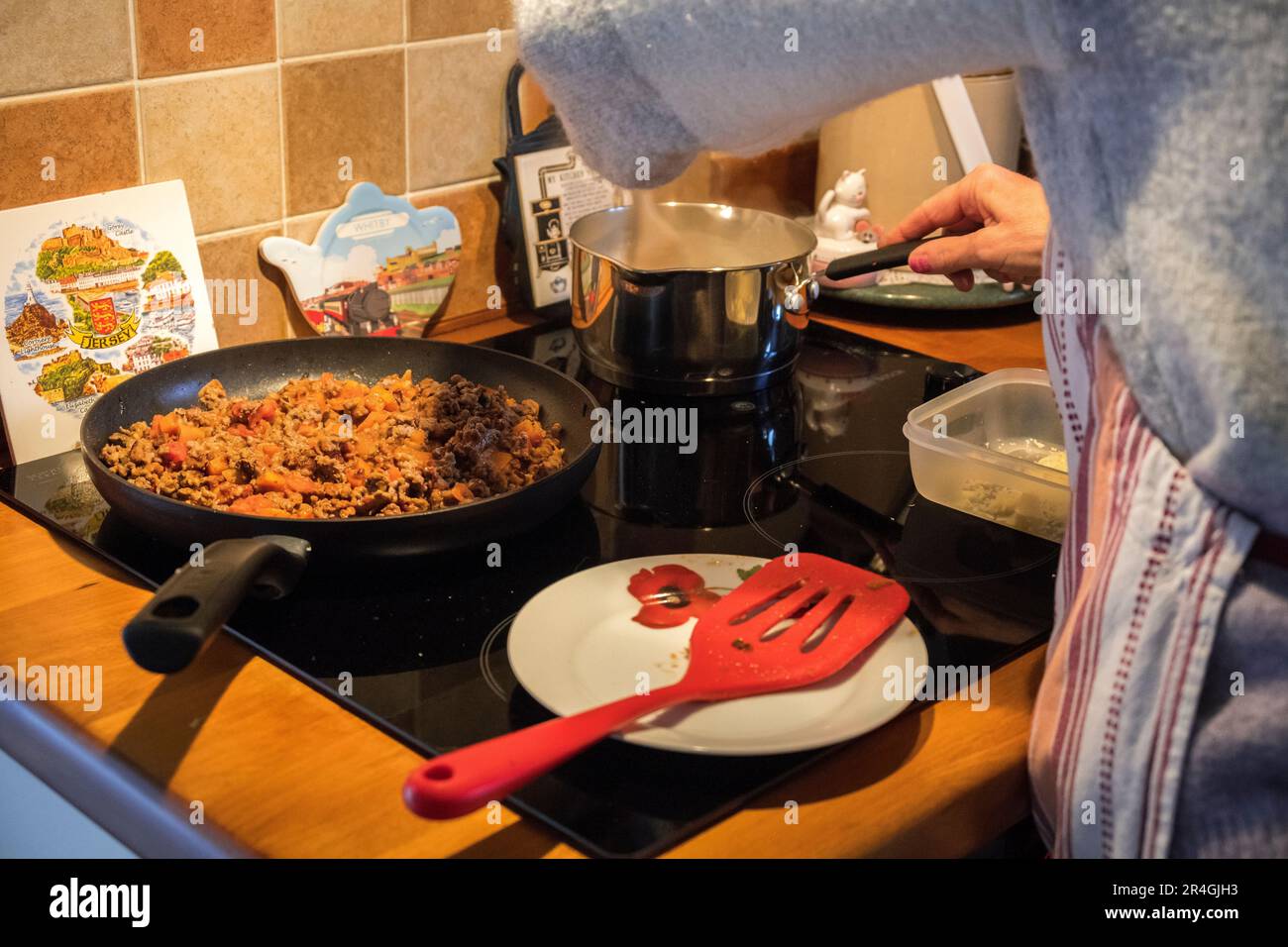 She busy cooking in the kitchen Stock Photo - Alamy