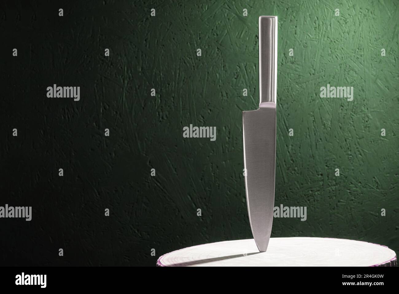 A professional kitchen knife, a knife stuck in wood. Close-up of a ...