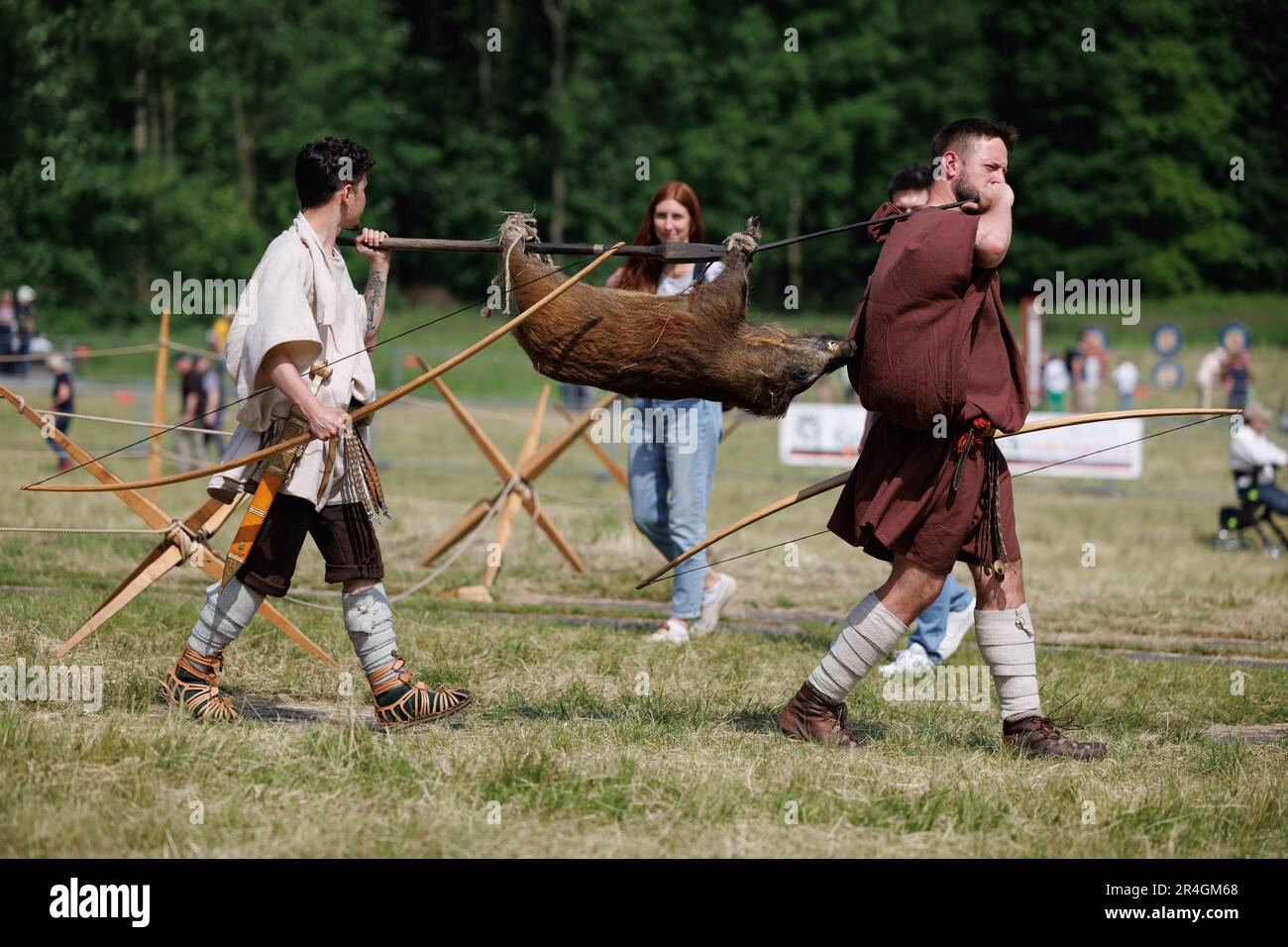 28 May 2023, Lower Saxony, Bramsche: Actors dressed as Romans carry a ...